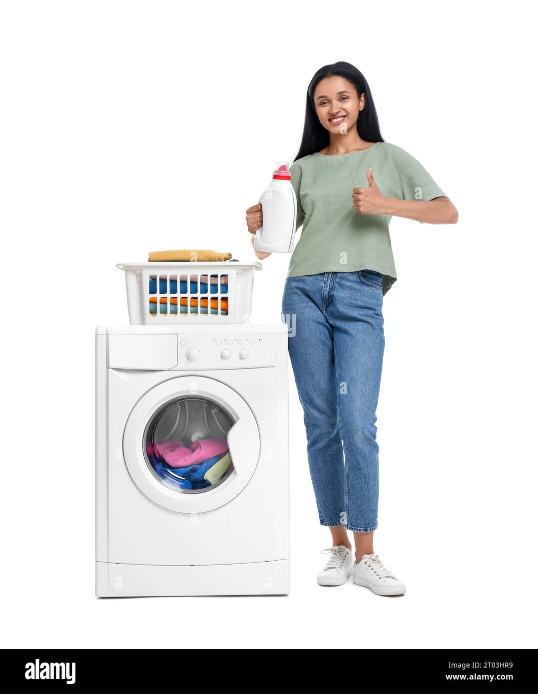 Beautiful woman with detergent showing thumb up near washing machine on white background Stock ...