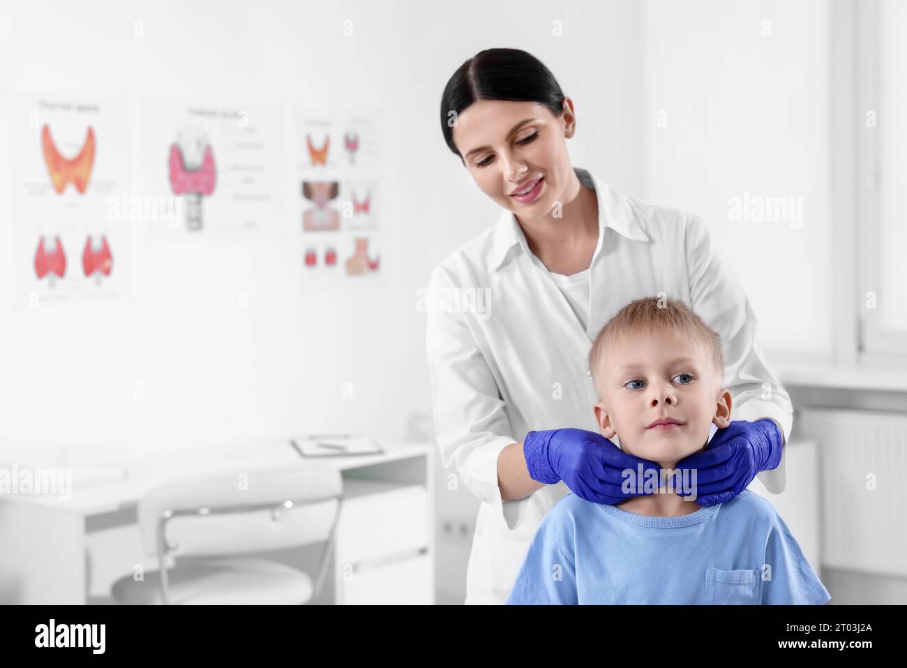 Endocrinologist examining boy's thyroid gland at hospital, space for ...