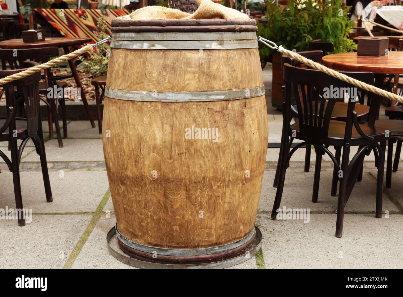 Traditional wooden barrel near street cafe outdoors Stock Photo - Alamy
