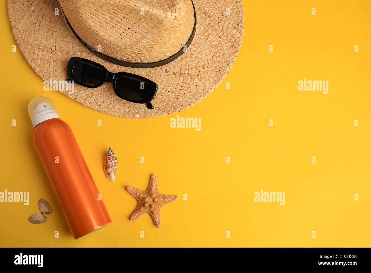 Flat lay composition with bottle of sunscreen on yellow background ...