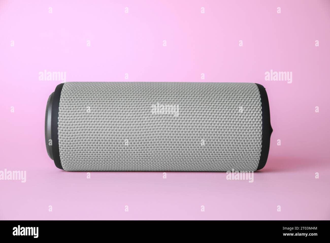 One portable bluetooth speaker on pink background. Audio equipment ...