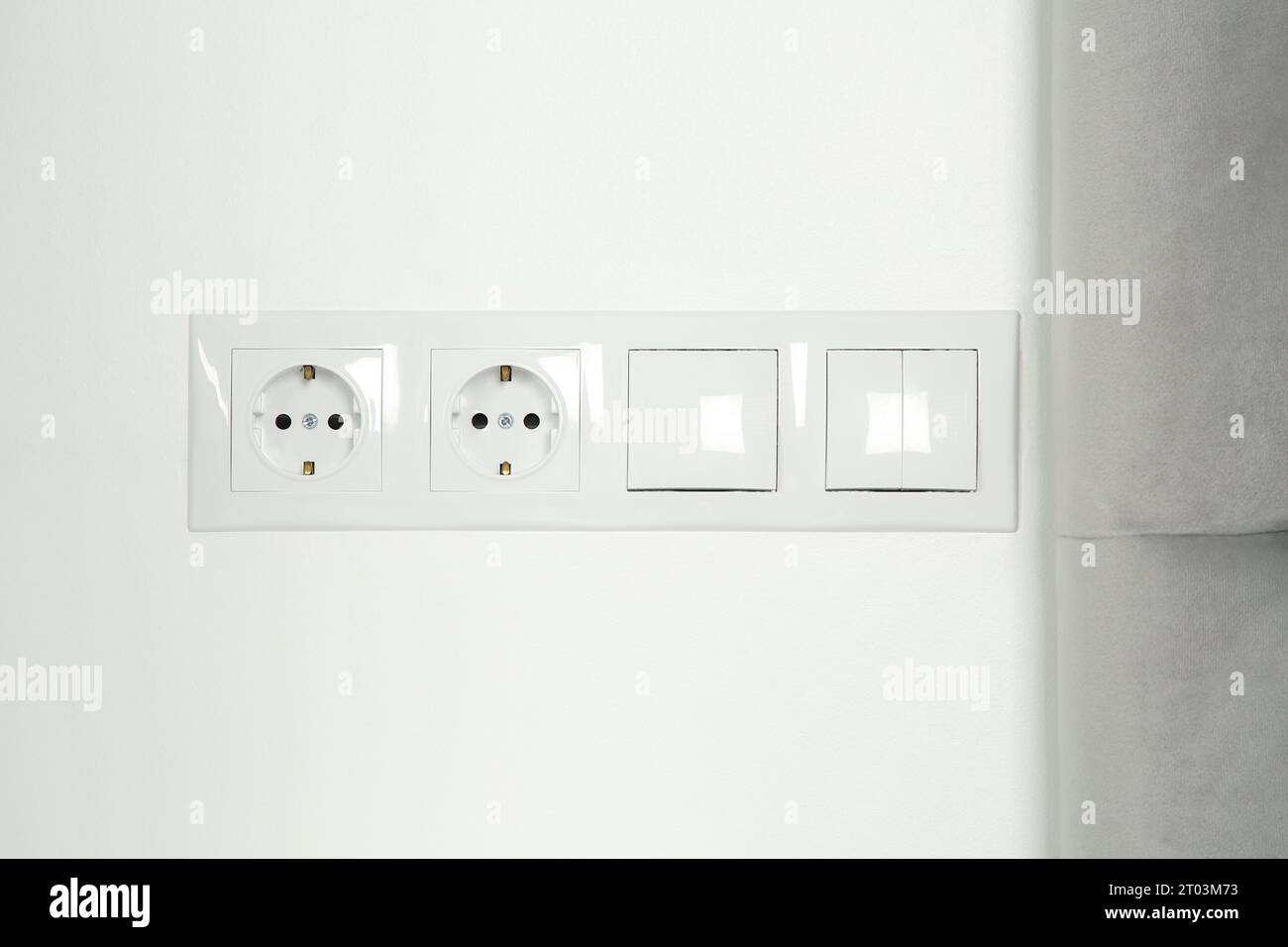 Light switches and power sockets on white wall indoors Stock Photo - Alamy