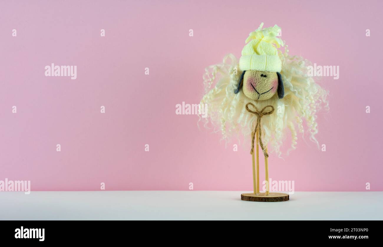 Handmade cute funny sheep toy with hat on pink background Stock Photo ...