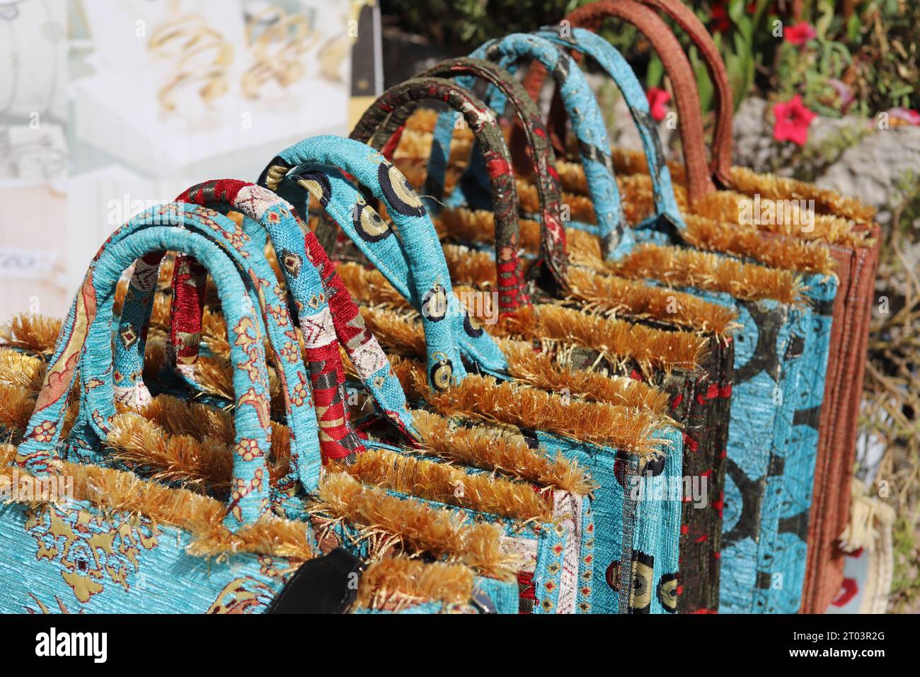 A row of quirky, unique, silky embroidered, multi coloured, Tote or ...