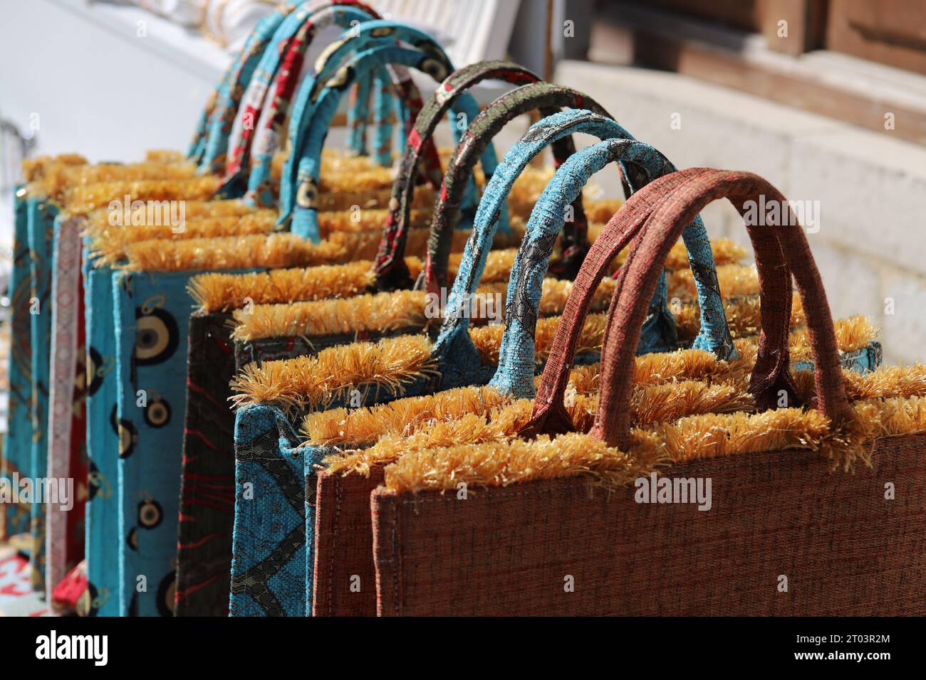 A row of quirky, unique, silky embroidered, multi coloured, Tote or ...