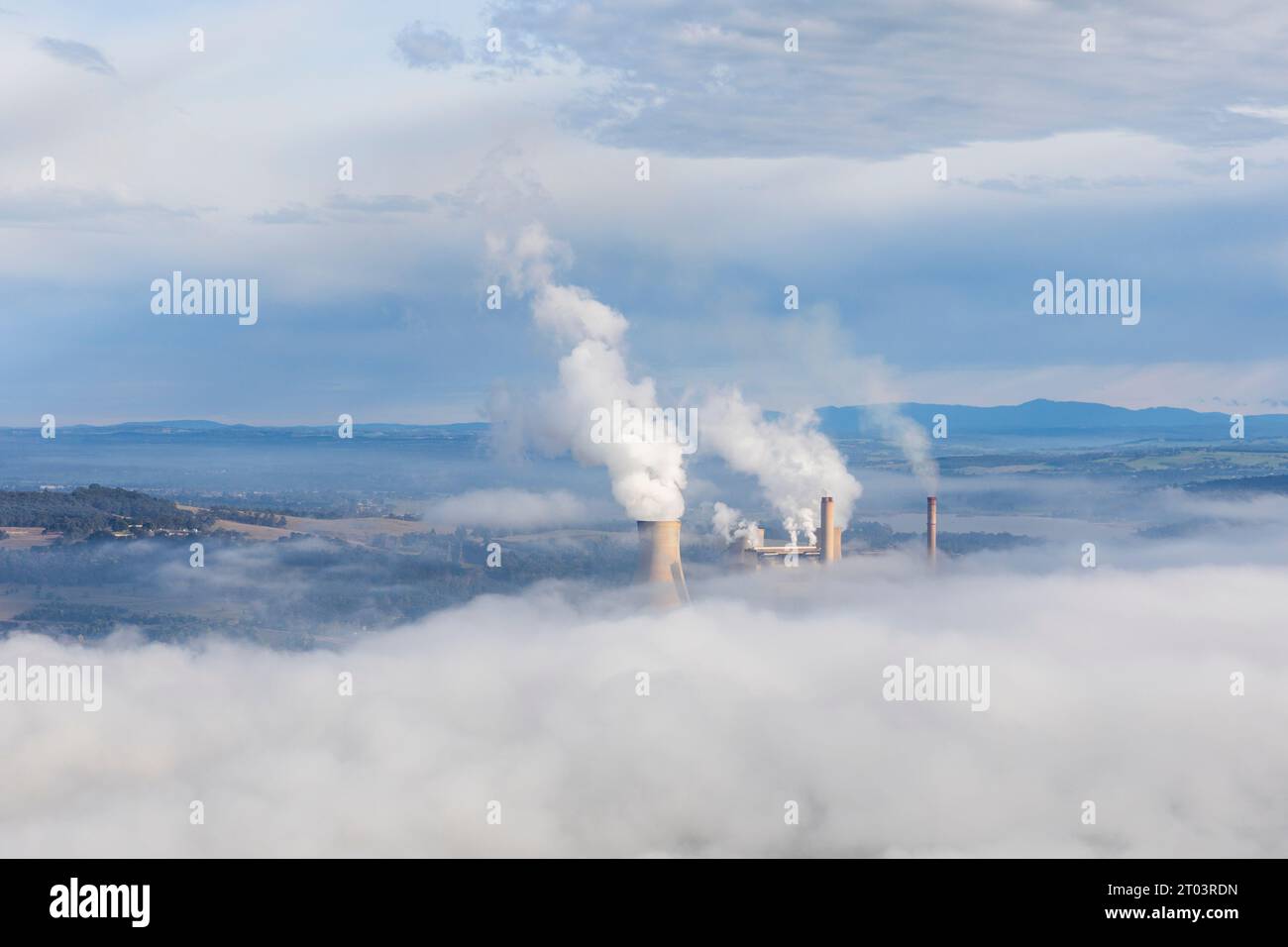 Aerial view capturing smoke rising from smokestacks and blending with ...