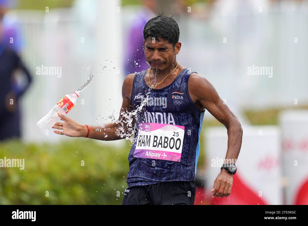 India's Ram Babo cools himself as he competes during the mixed teams 35 ...