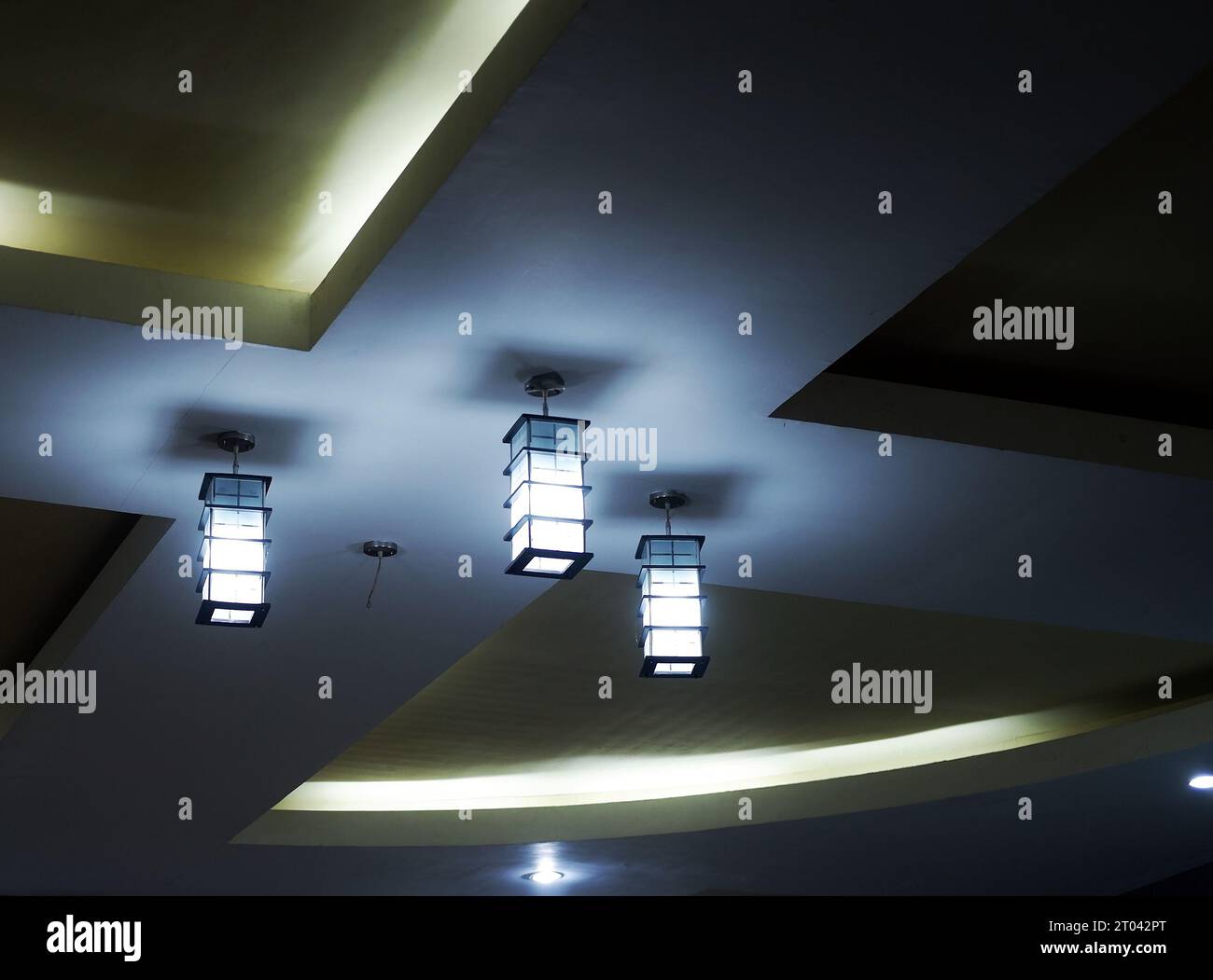 Three box-shaped lights are installed above the ceiling of the room ...