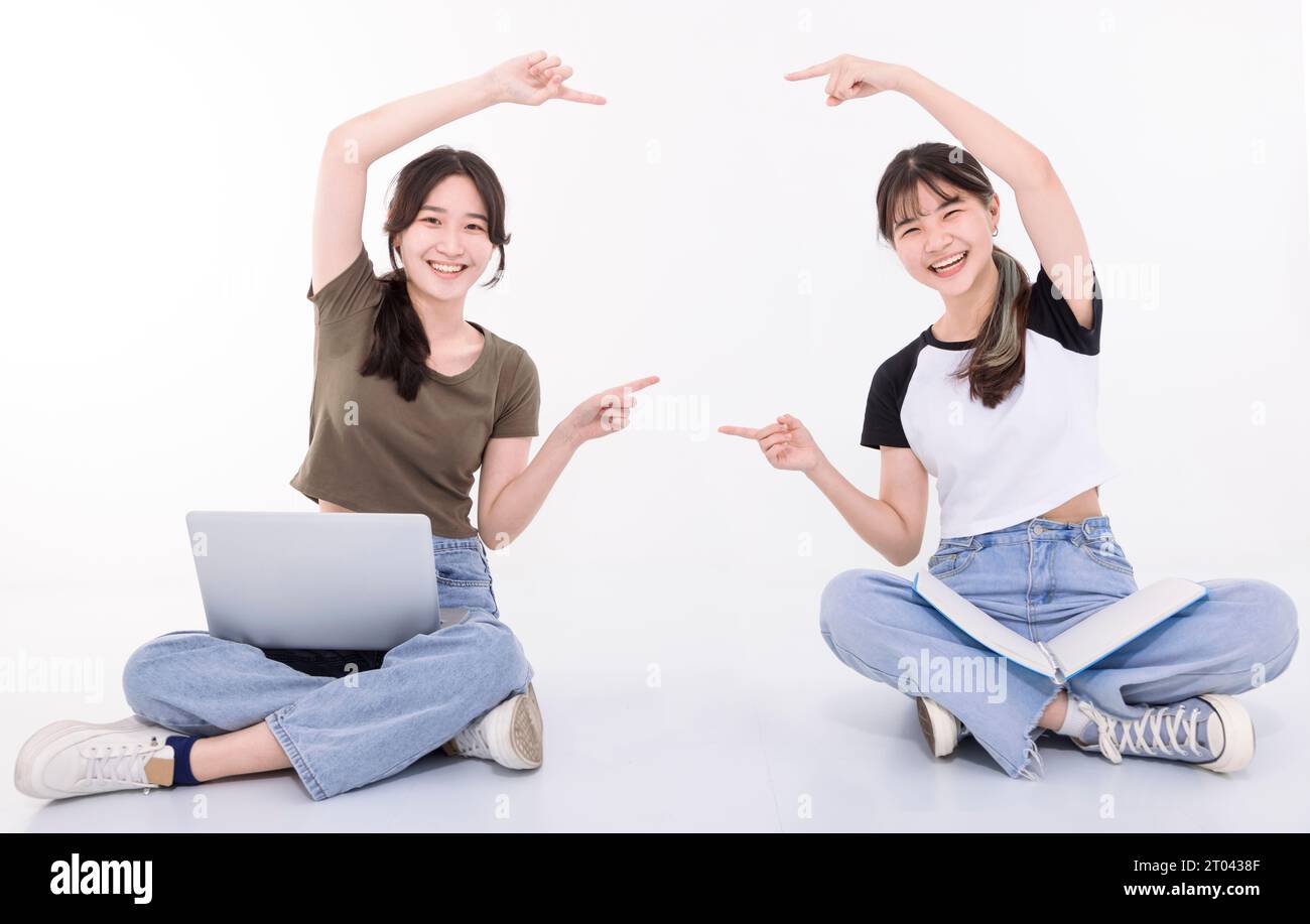 Young teenager girls student point finger on each other Stock Photo - Alamy
