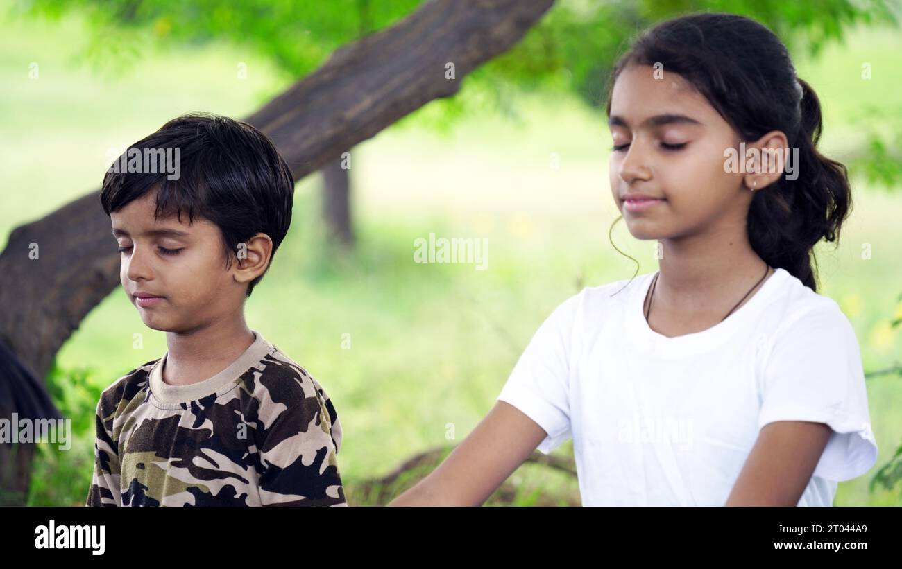 Portrait of gorgeous kid practicing yoga outdoor. Beautiful child ...