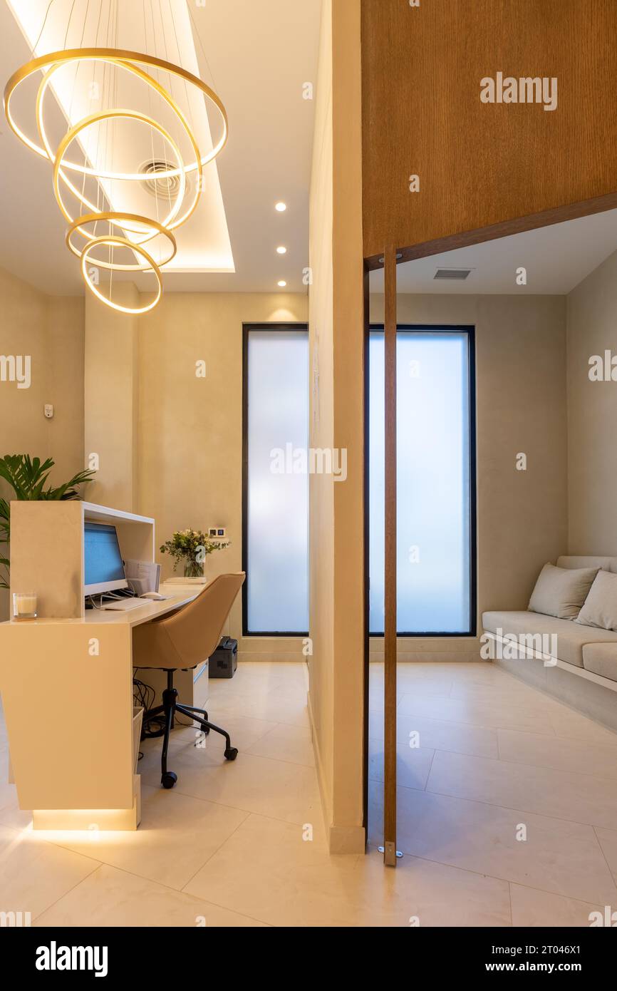 Vertical photo of en elegant entrance of a clinic with reception and ...