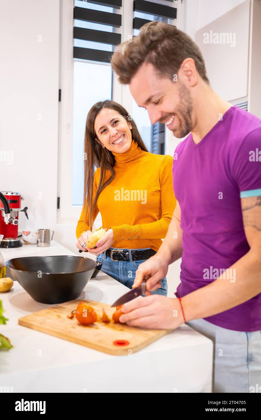 Vertical photo of a happy family cooking healthy food together at home ...