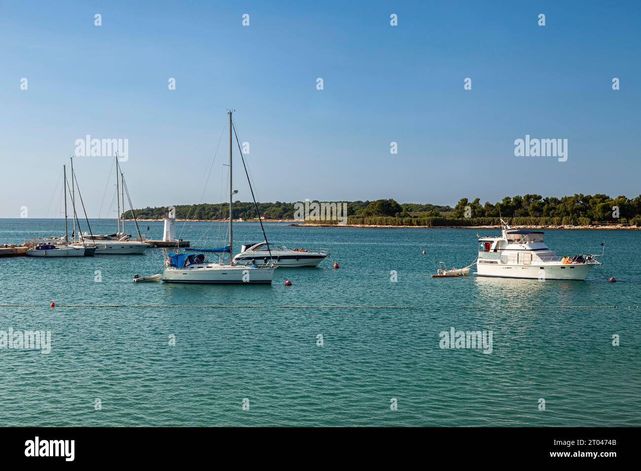 Sailboats anchor in the harbor entrance of Novigrad, Istria County ...