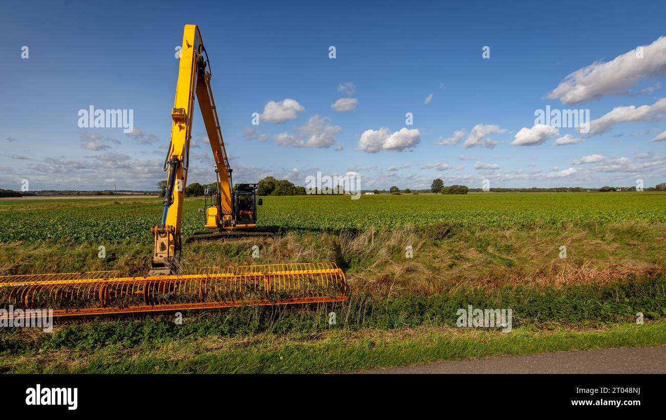 Reed cutting excavator clearing drainage ditches in the flat lands of ...