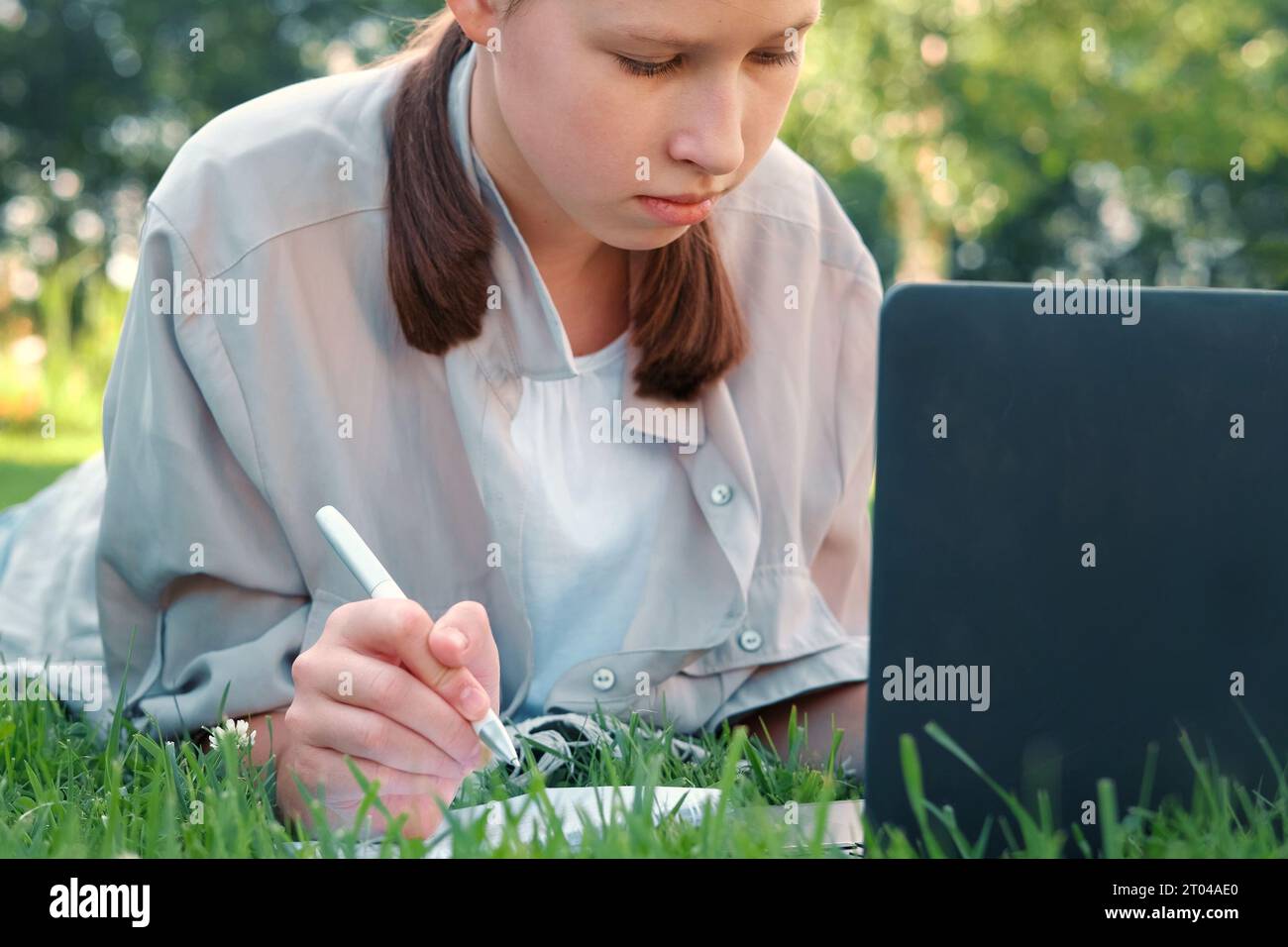 Teenage schoolgirl studying reading her books, tablet and notebook ...