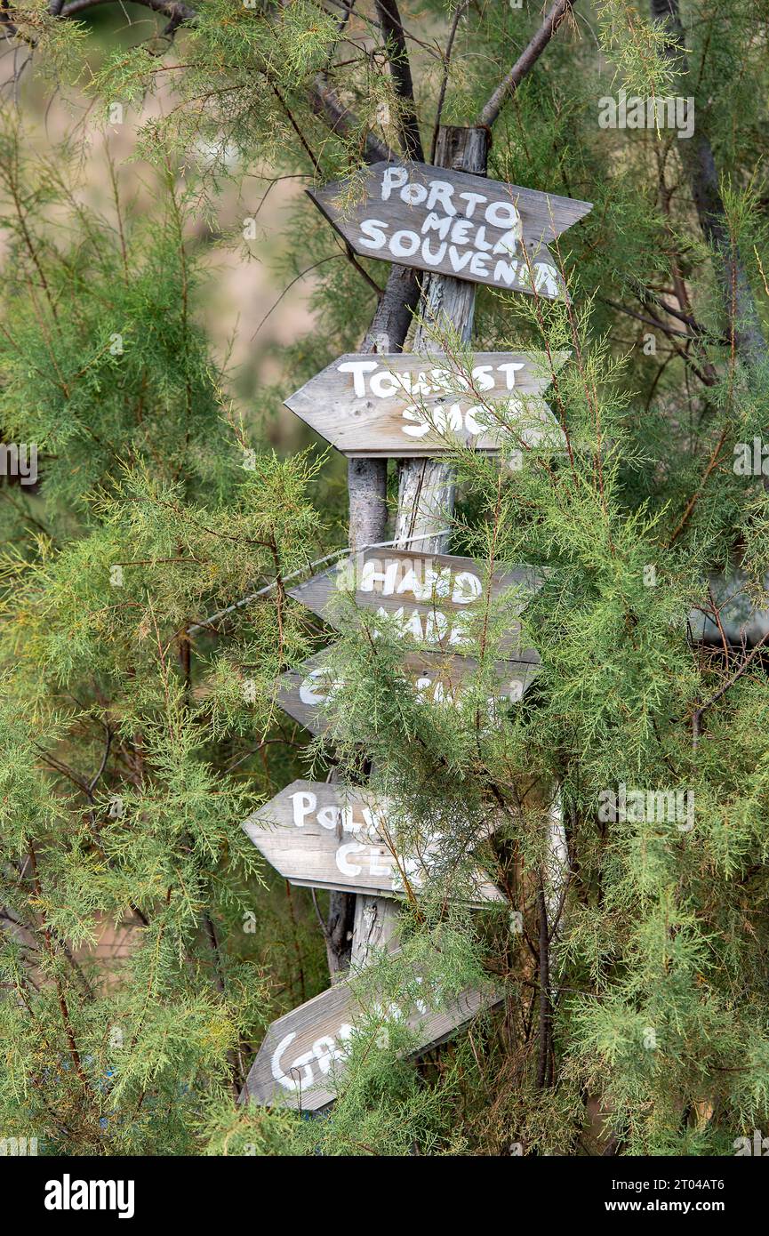 old wooden shabby chic or rustic direction signs on a post at the beach ...