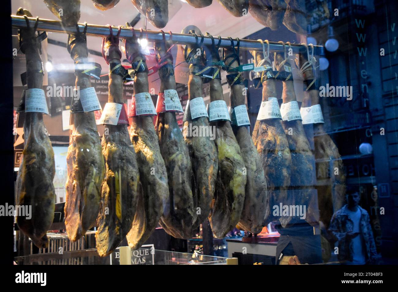 Cured Spanish hams hanging in a shop window. Barcelona, Catalonia ...