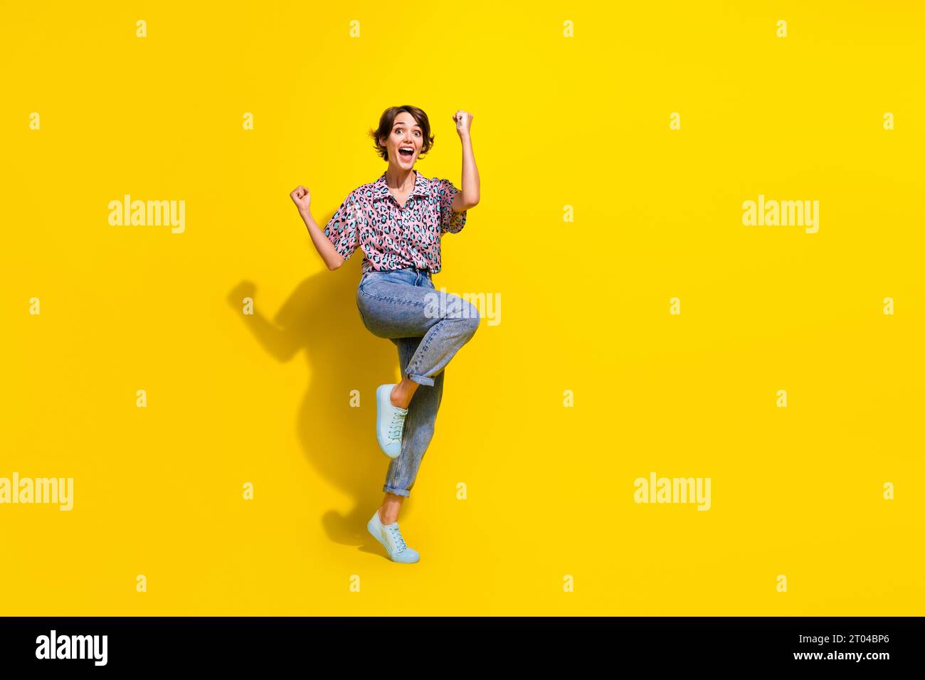 Full size portrait of overjoyed cheerful girl raise fists shout yes ...