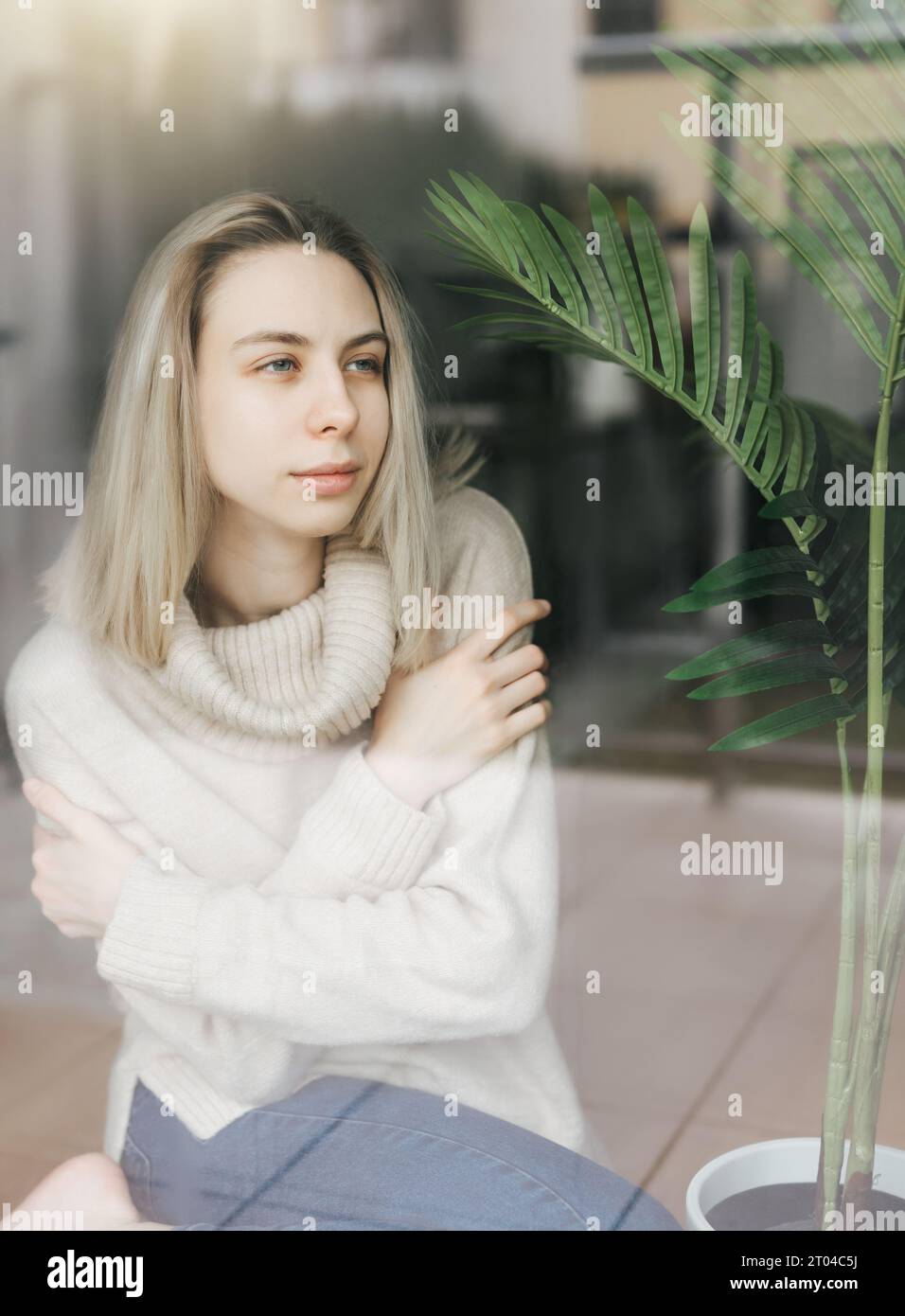 Sad girl near window thinking about something. Stressed lady feel ...