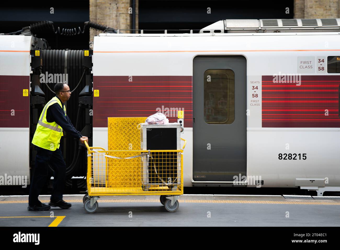 A member of staff at Kings Cross station in London as members of the ...
