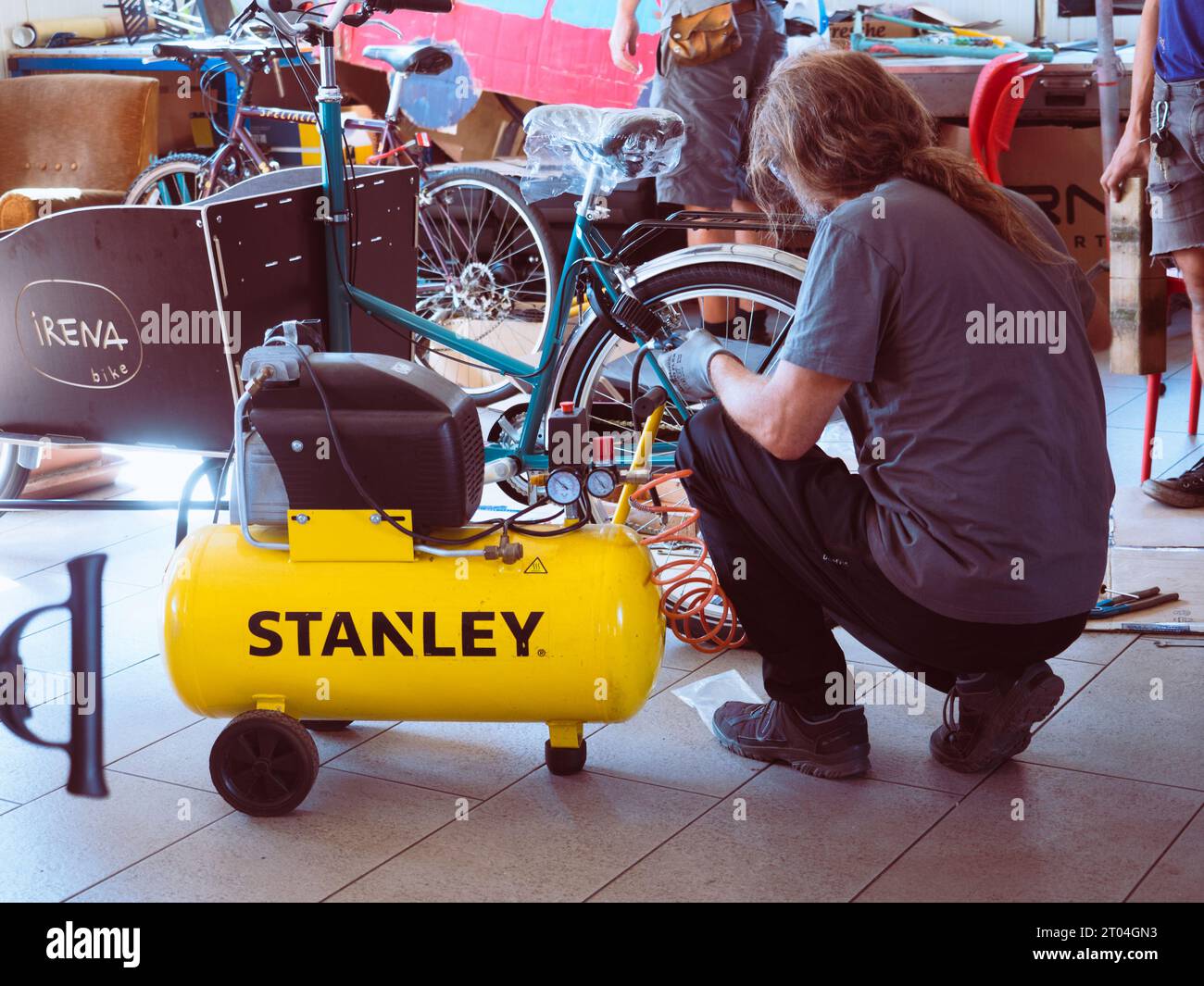 at the bike shop store and repair , old caucasian mechanic expert ...