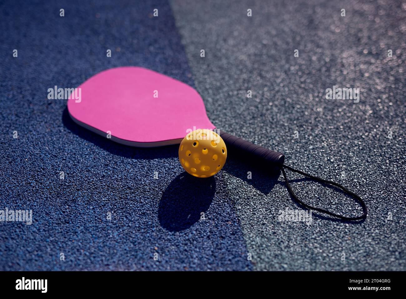 Paddle racket for pickleball lying on the court ground Stock Photo - Alamy
