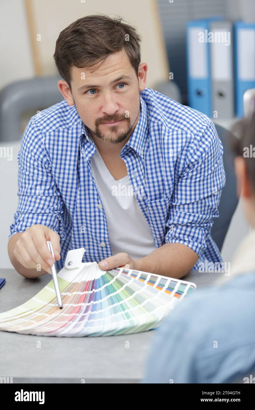 man picking a color for his customers house walls Stock Photo - Alamy