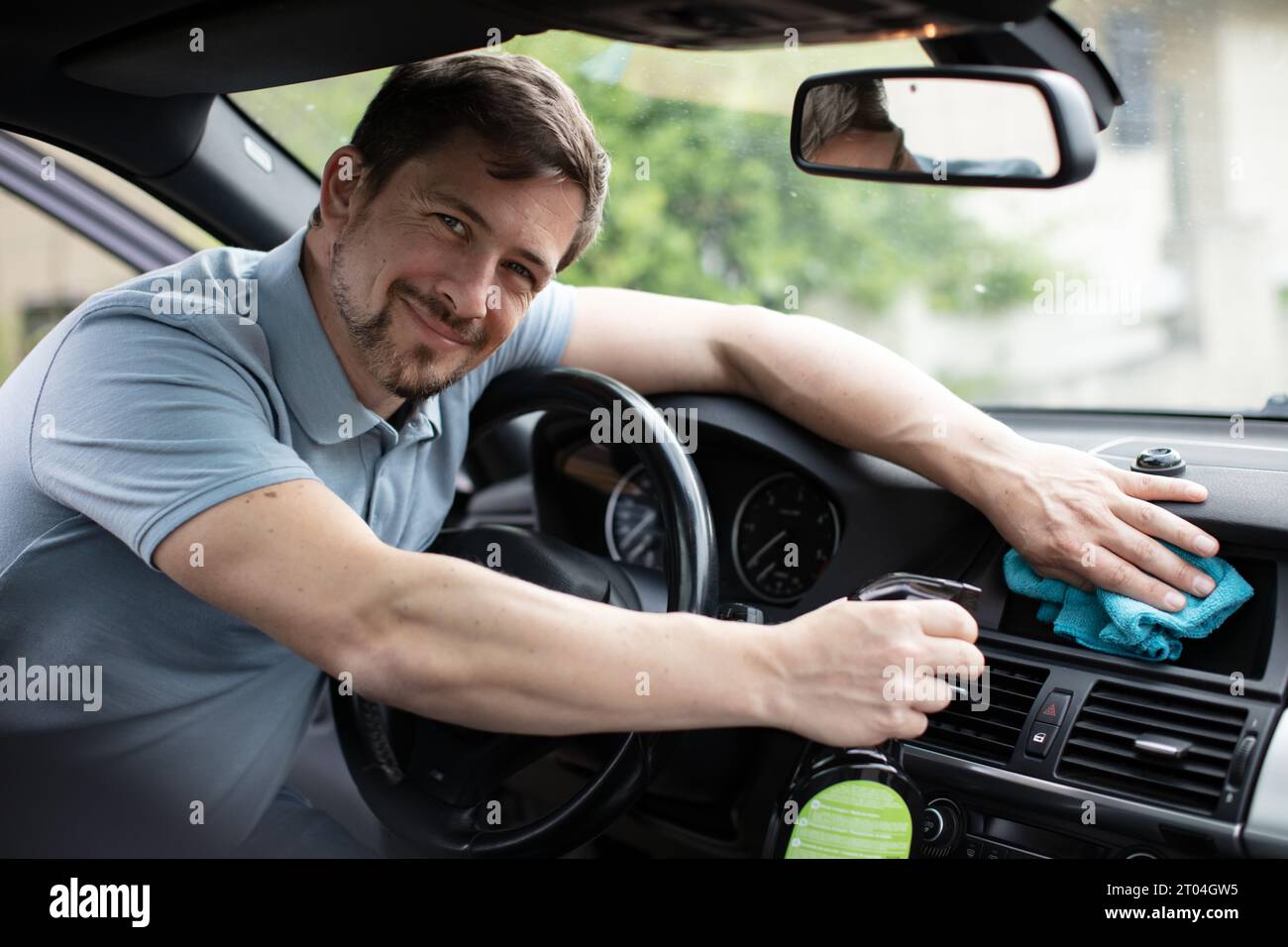 happy man cleaning car interior Stock Photo - Alamy