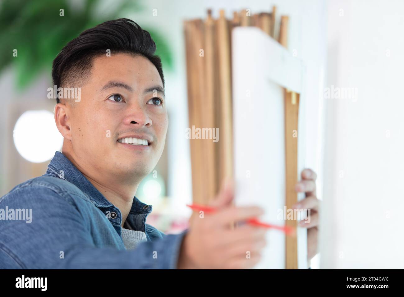 side view of a male artist drawing in studio Stock Photo - Alamy