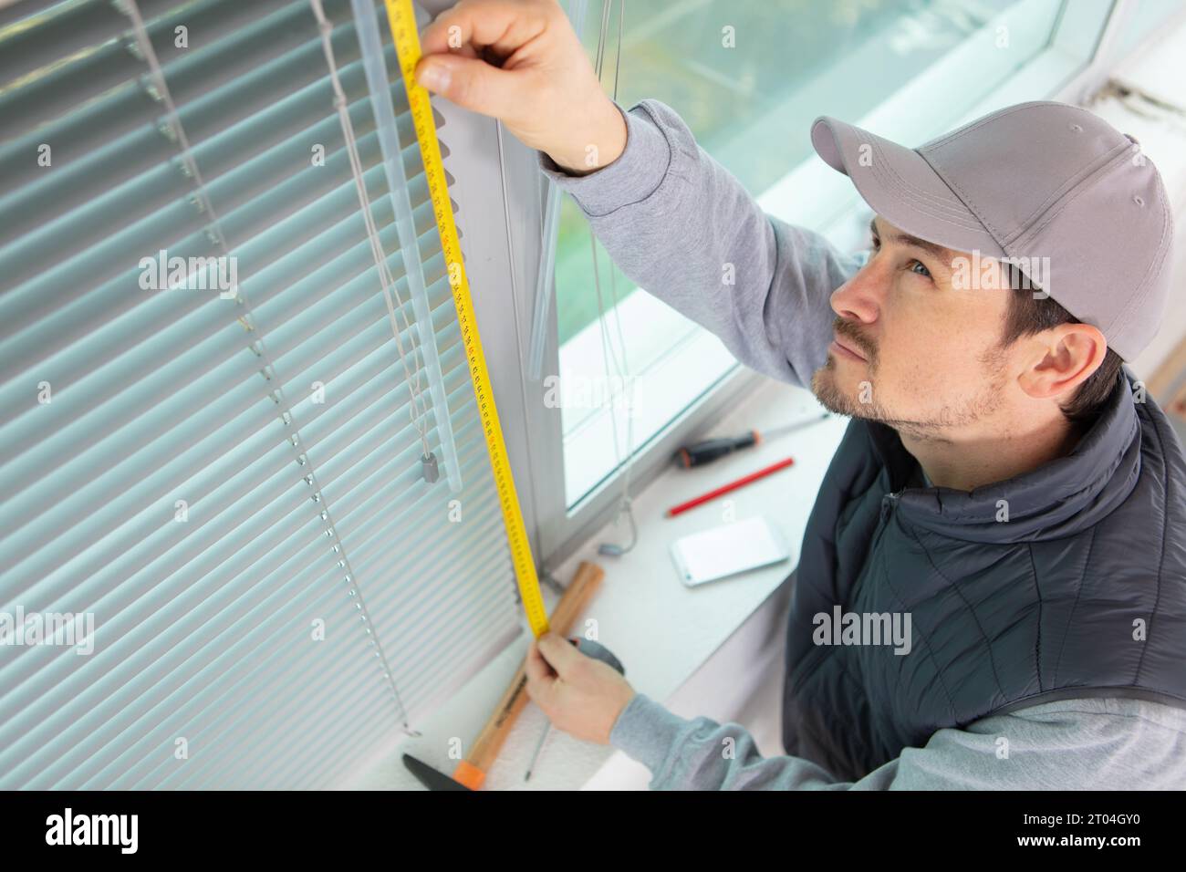 foreman checking accuracy with a tape measure Stock Photo - Alamy