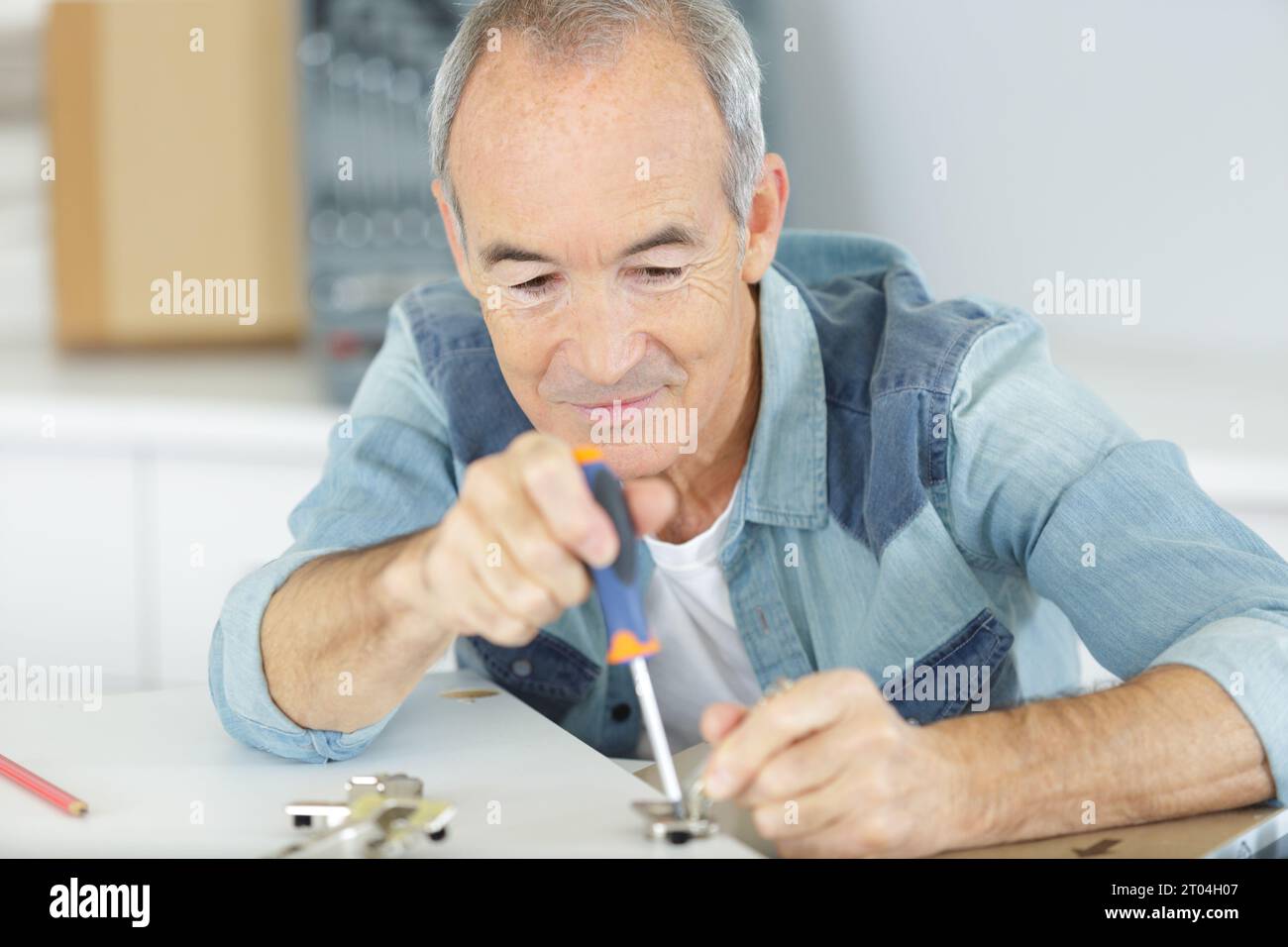 Senior worker using tools hi-res stock photography and images - Alamy