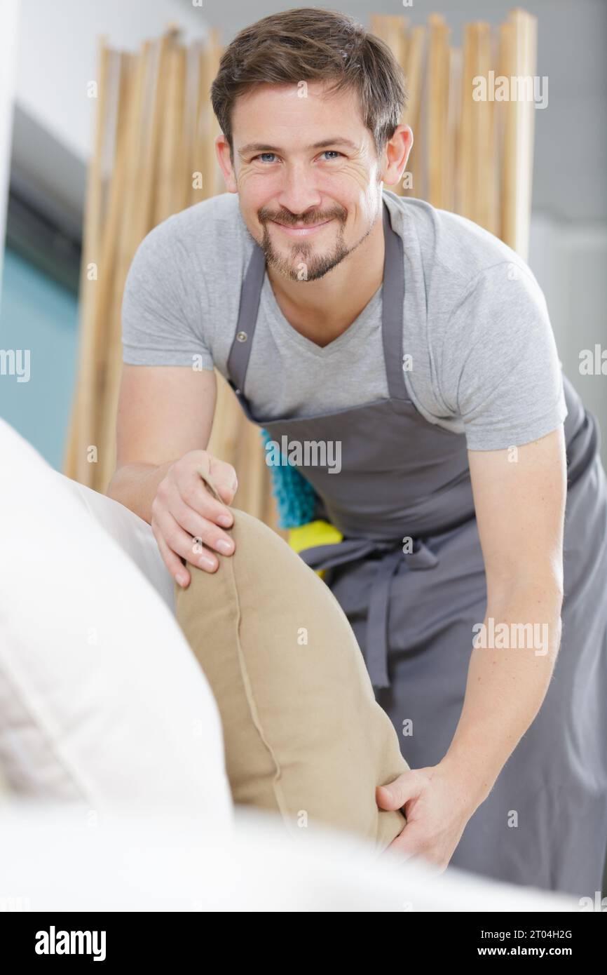 man in uniform tidying up a flat Stock Photo - Alamy