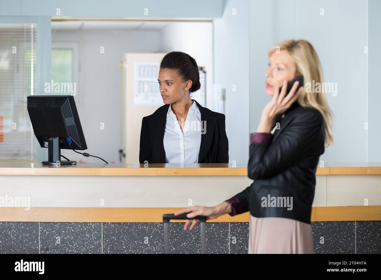 kind female receptionist wish welcome to guest Stock Photo - Alamy