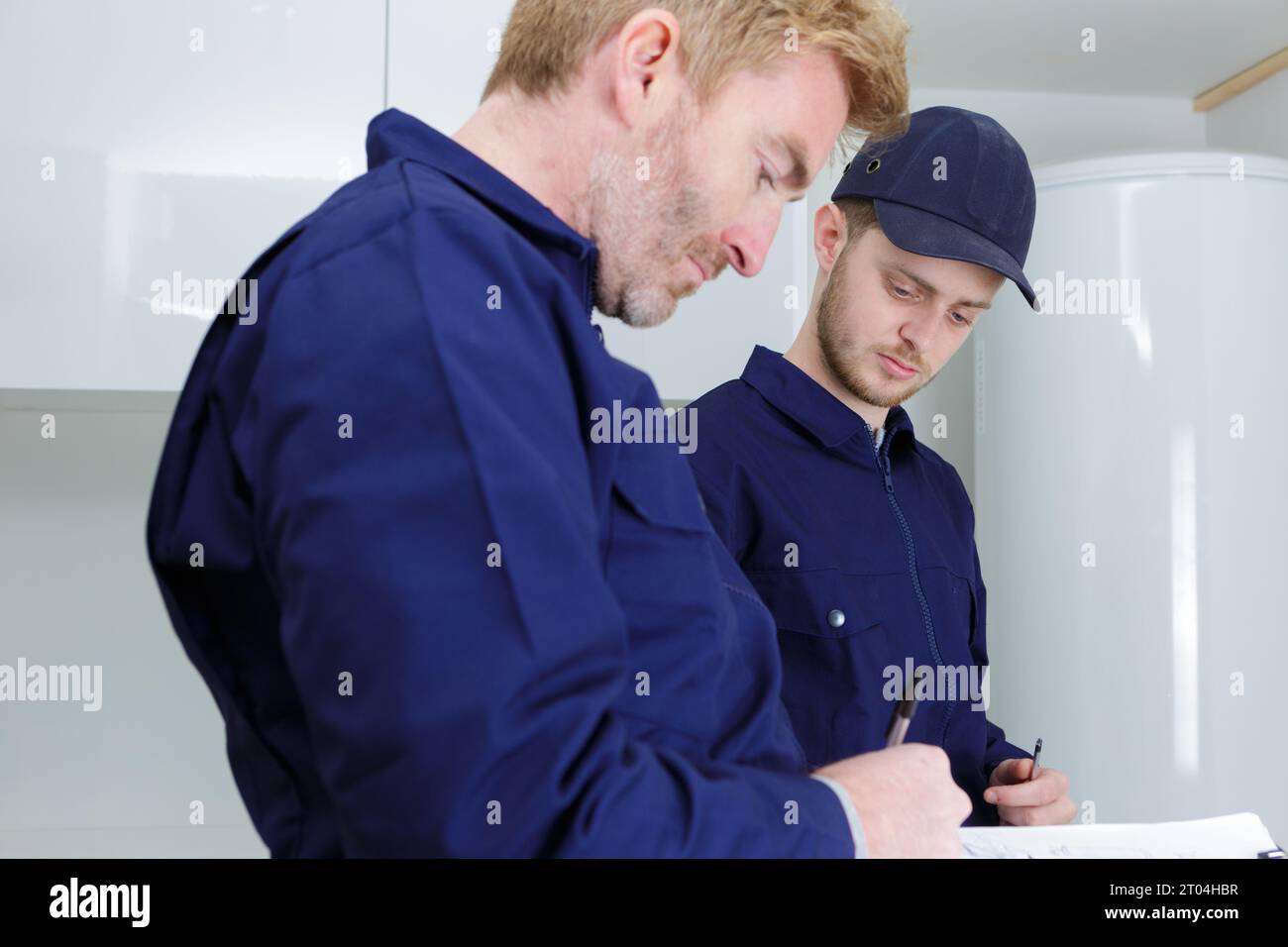two plumbers at work Stock Photo - Alamy