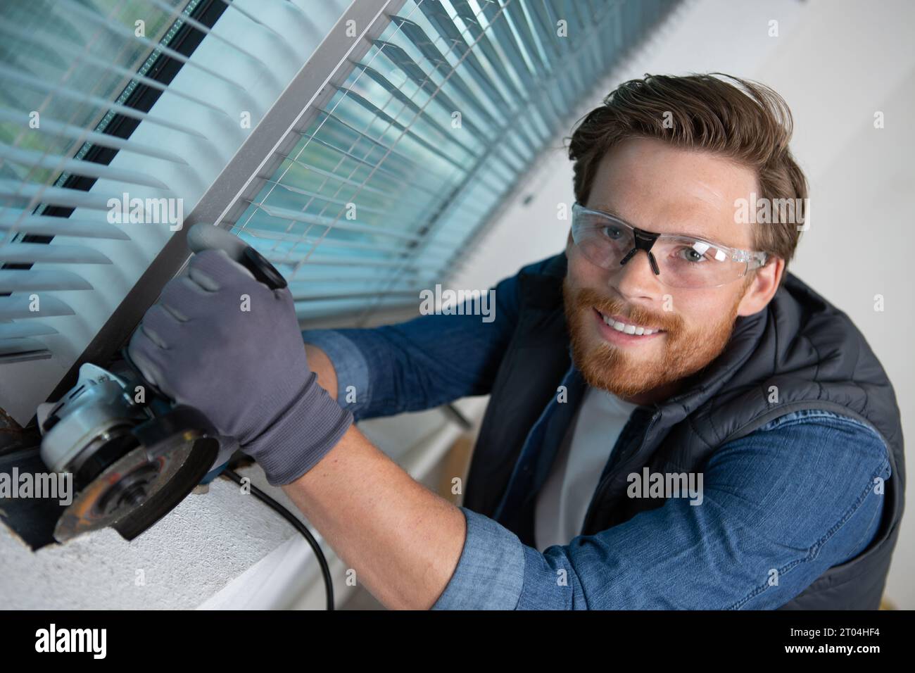 construction worker cutting concrete wall by using handheld circular ...
