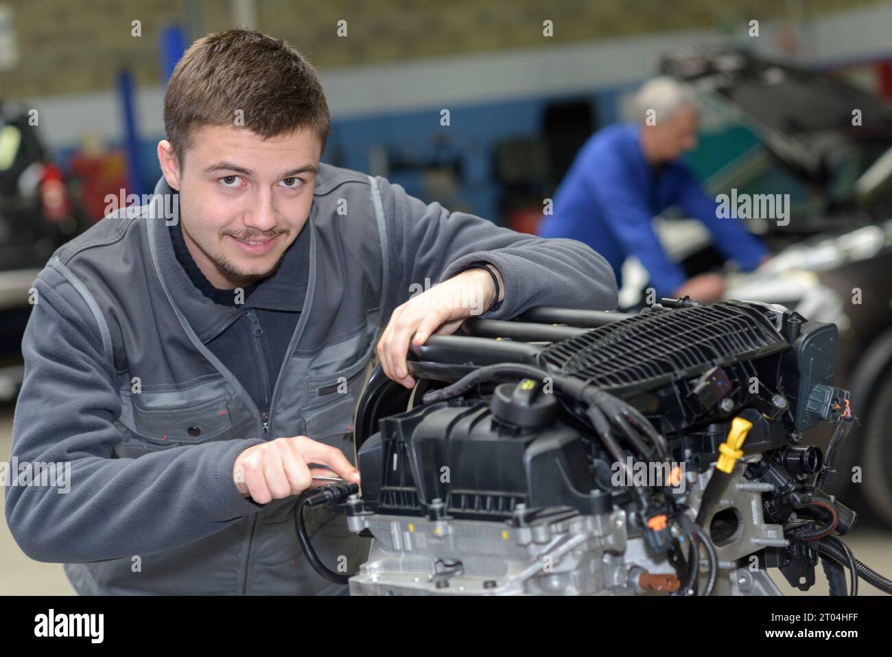 auto mechanic shows trainee maintenance of car engine Stock Photo - Alamy