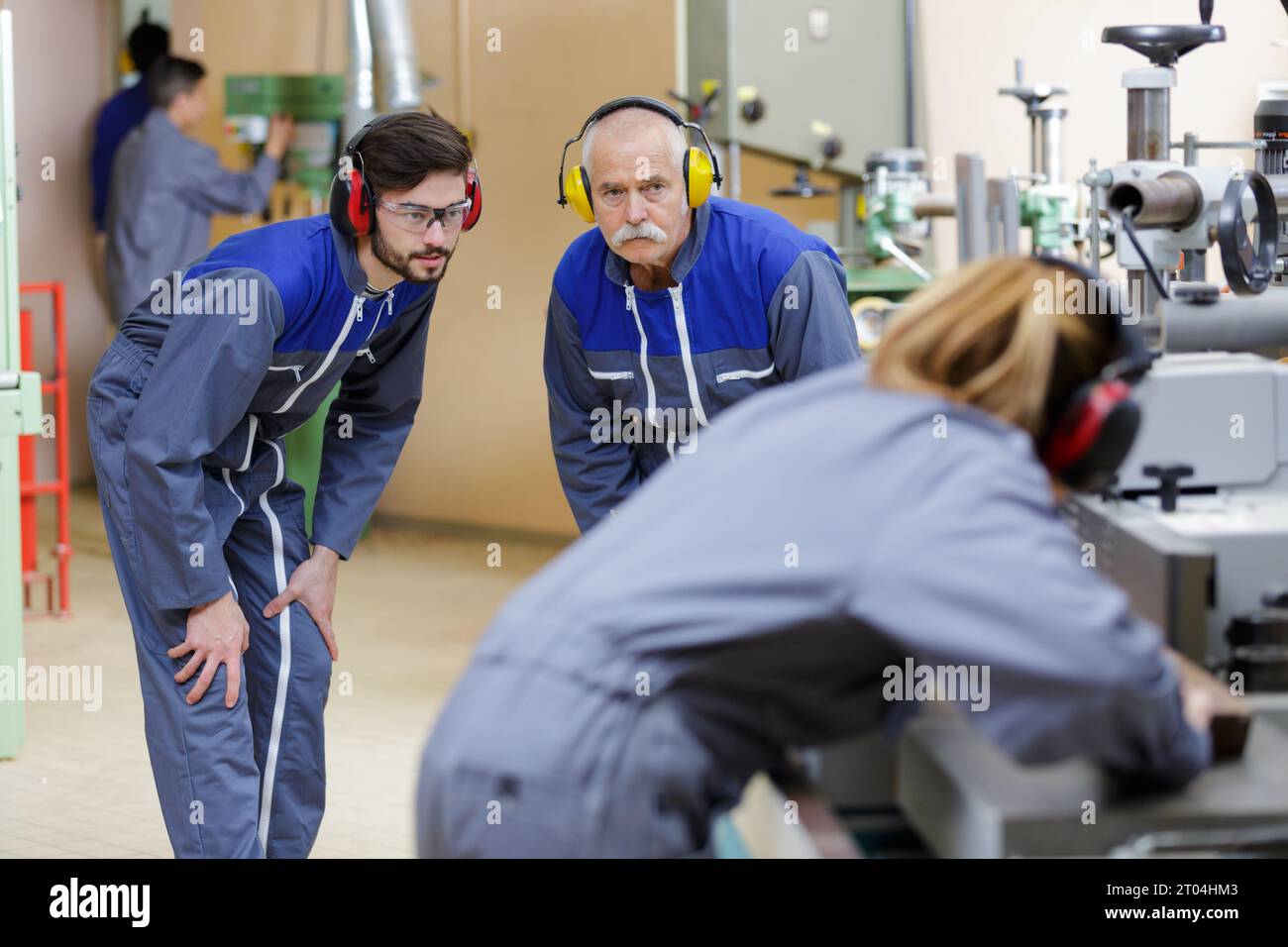 observing a female machine wood operator Stock Photo - Alamy