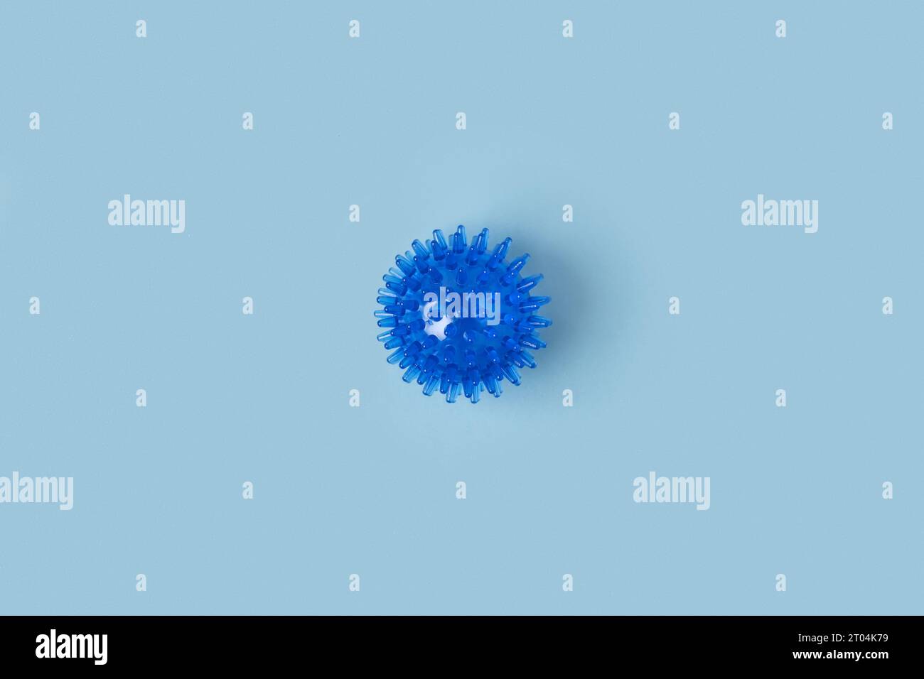 Tactile knobby ball on blue studio background. Sensory massage textured ...