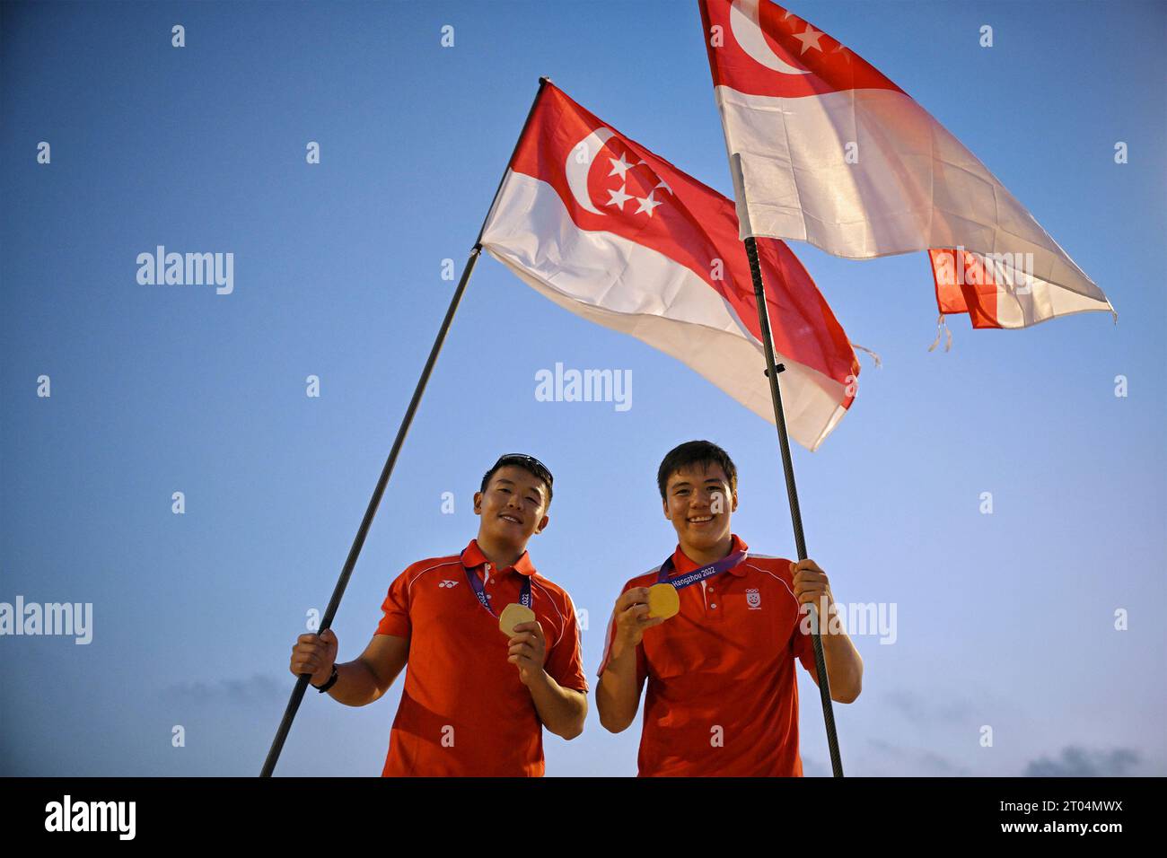 Sailors Max Maeder (right) and Ryan Lo pose with their gold medals at ...