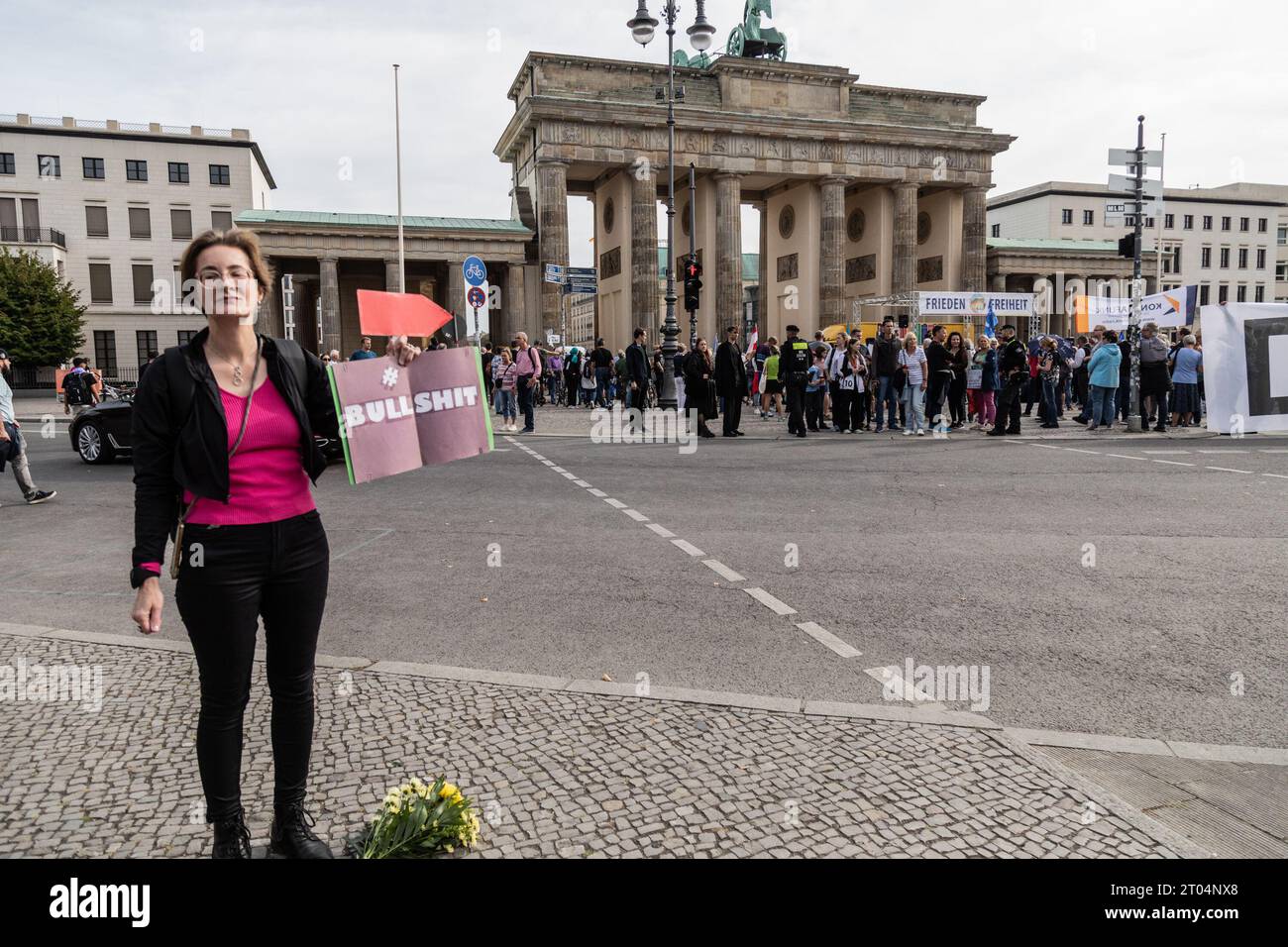 A counter protestor holds up a placard that says "Bullshit" across the ...