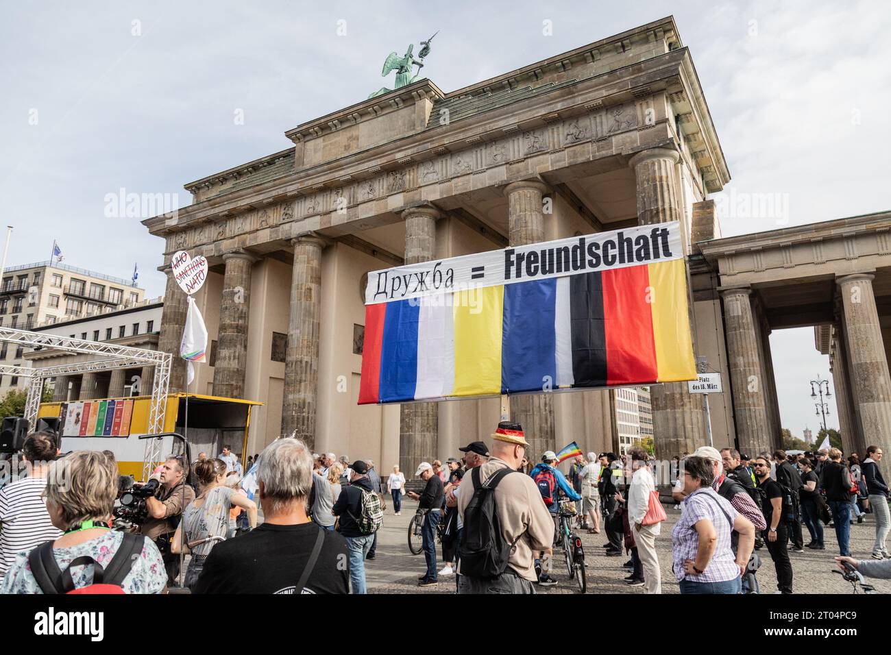 Berlin, Germany. 03rd Oct, 2023. A demonstrator holds a banner that ...