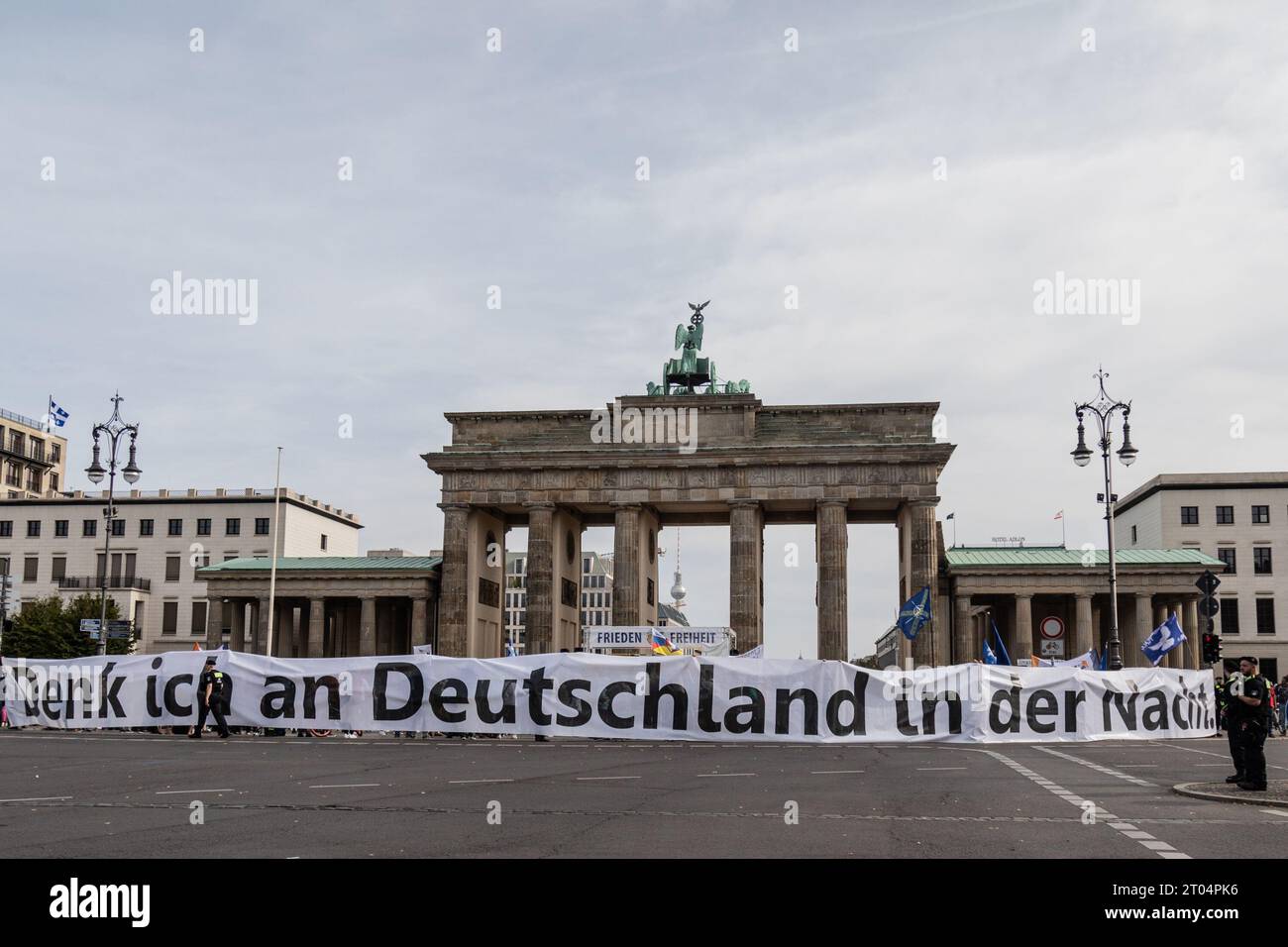 Demonstrators with a banner saying "I think of Germany in the night ...