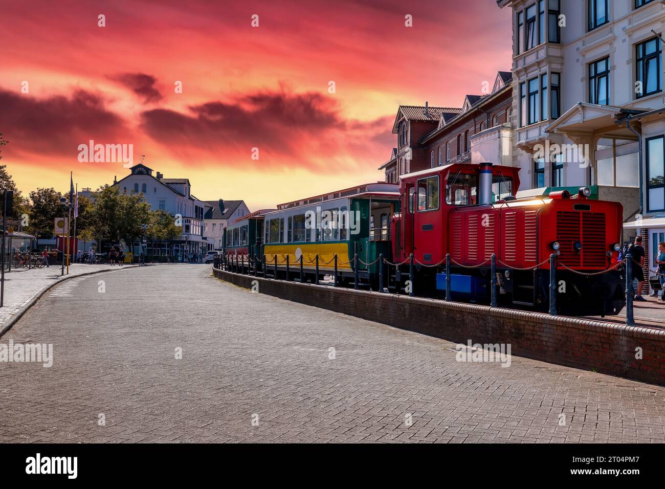 The famous passenger train of the german island of Borkum at sunset ...