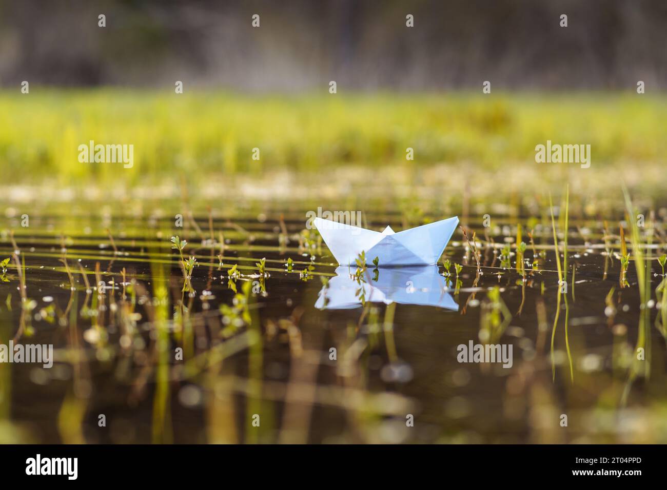 Picture capturing delicate, lonely paper boat made of white thin ...