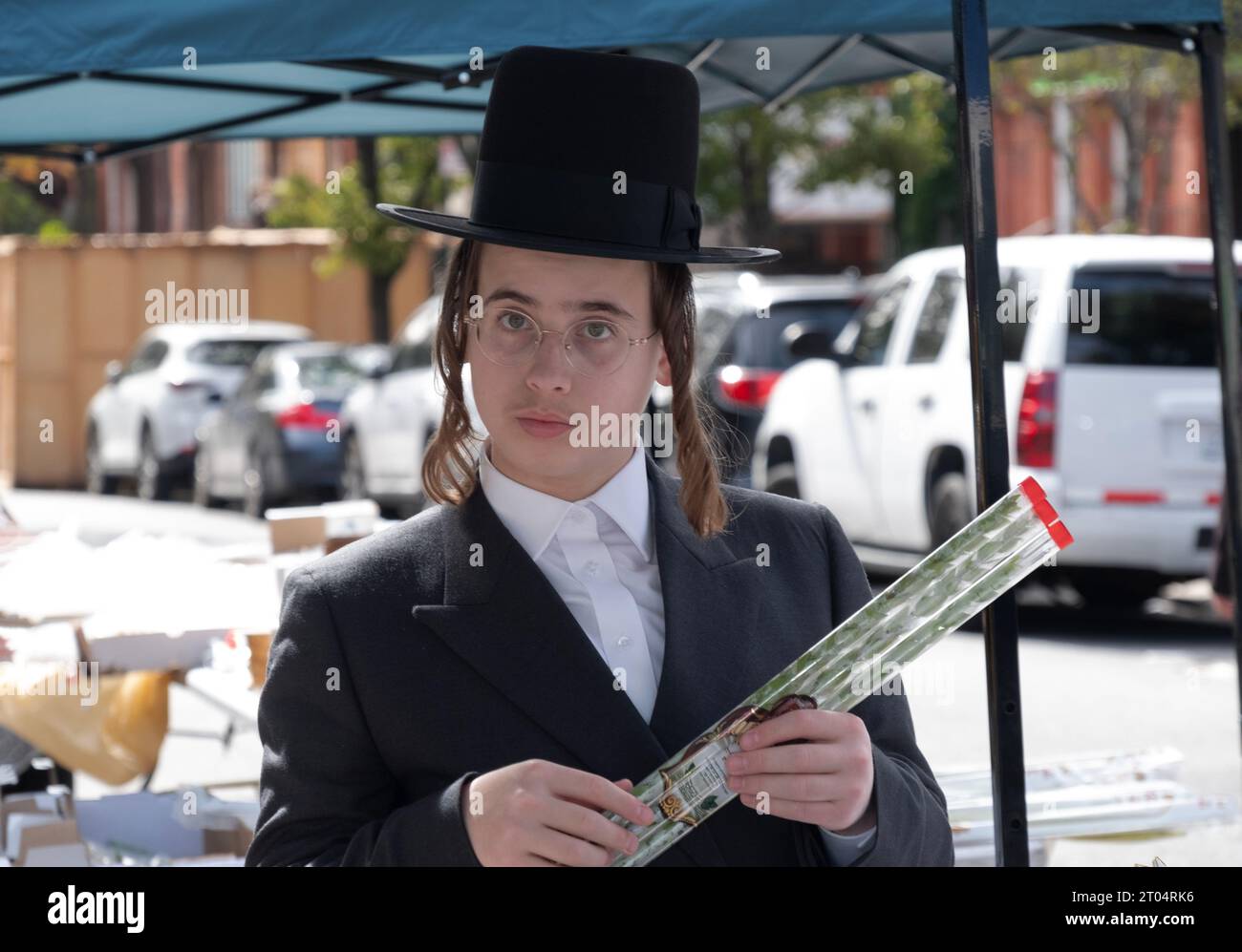 An orthodox Jewish man multitasks - talking on the fip phone and buying ...