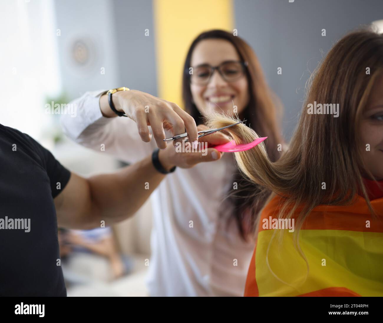 Student in hairdressing is learning how to cut hair Stock Photo - Alamy