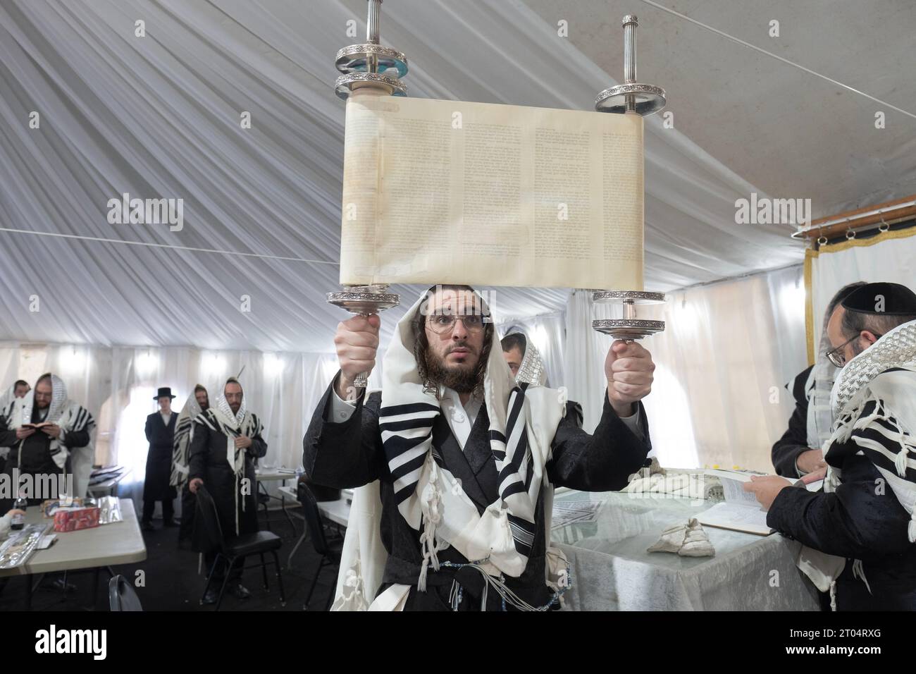 At a a synagogue and after a reading, a rabbi holds the Torah so that ...