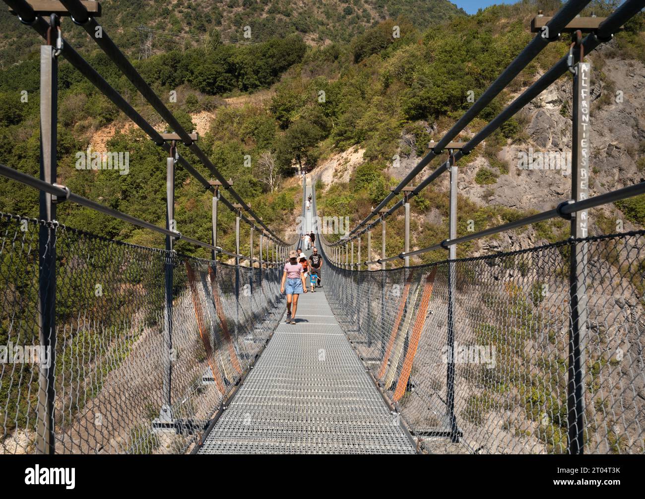 People cross the Passerelle du Drac (Drac Footbridge) over Lake ...