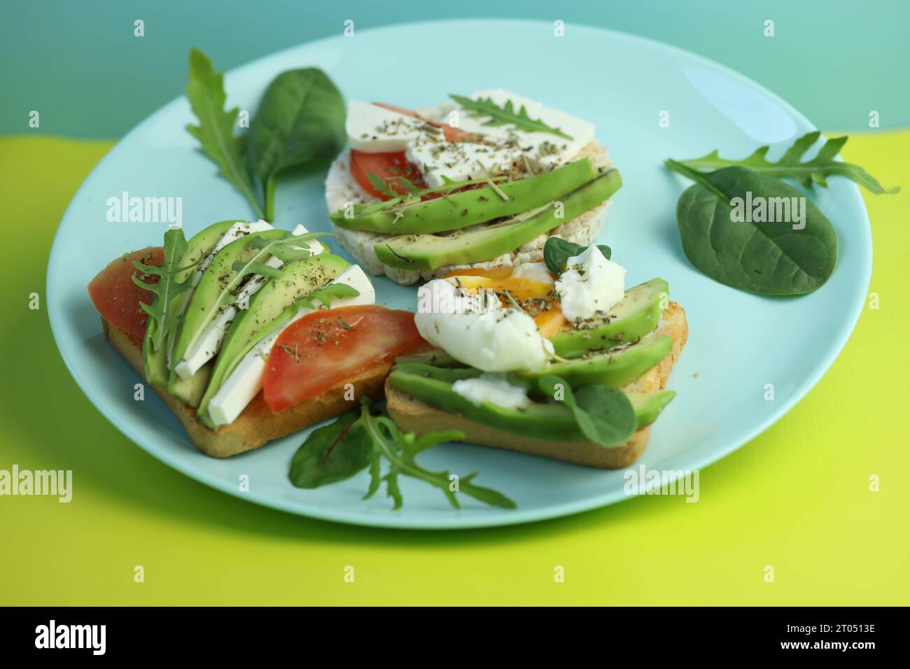Diet toasts with cheese, salad, avocado, tomato and eggs. Healthy ...