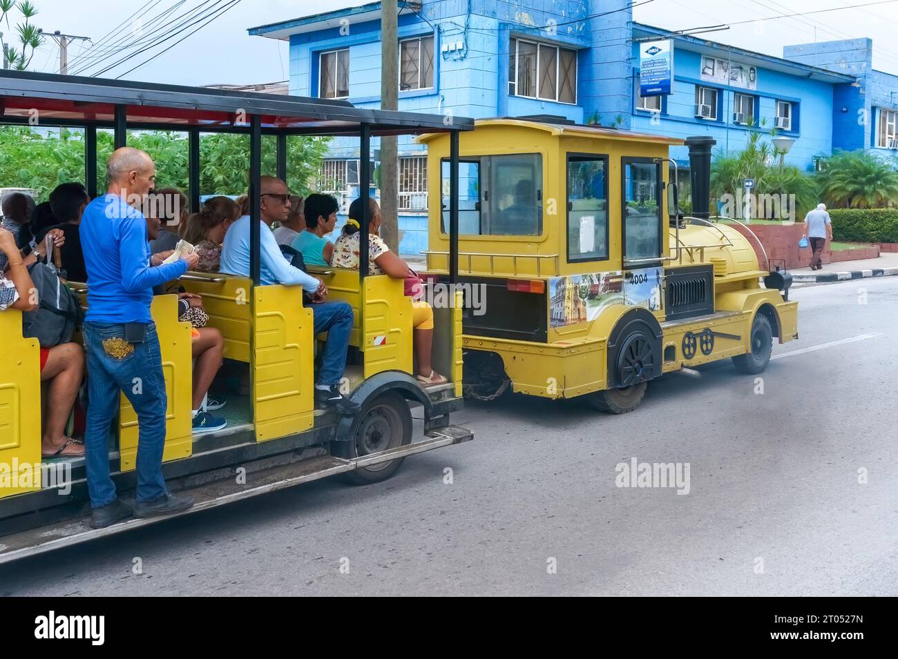 Real people on a motor vehicle with the resemblance of a vapor train ...